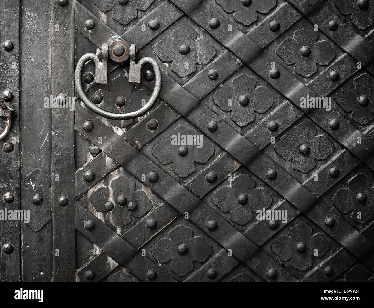 Old black door with rivets and flower pattern Stock Photo - Alamy