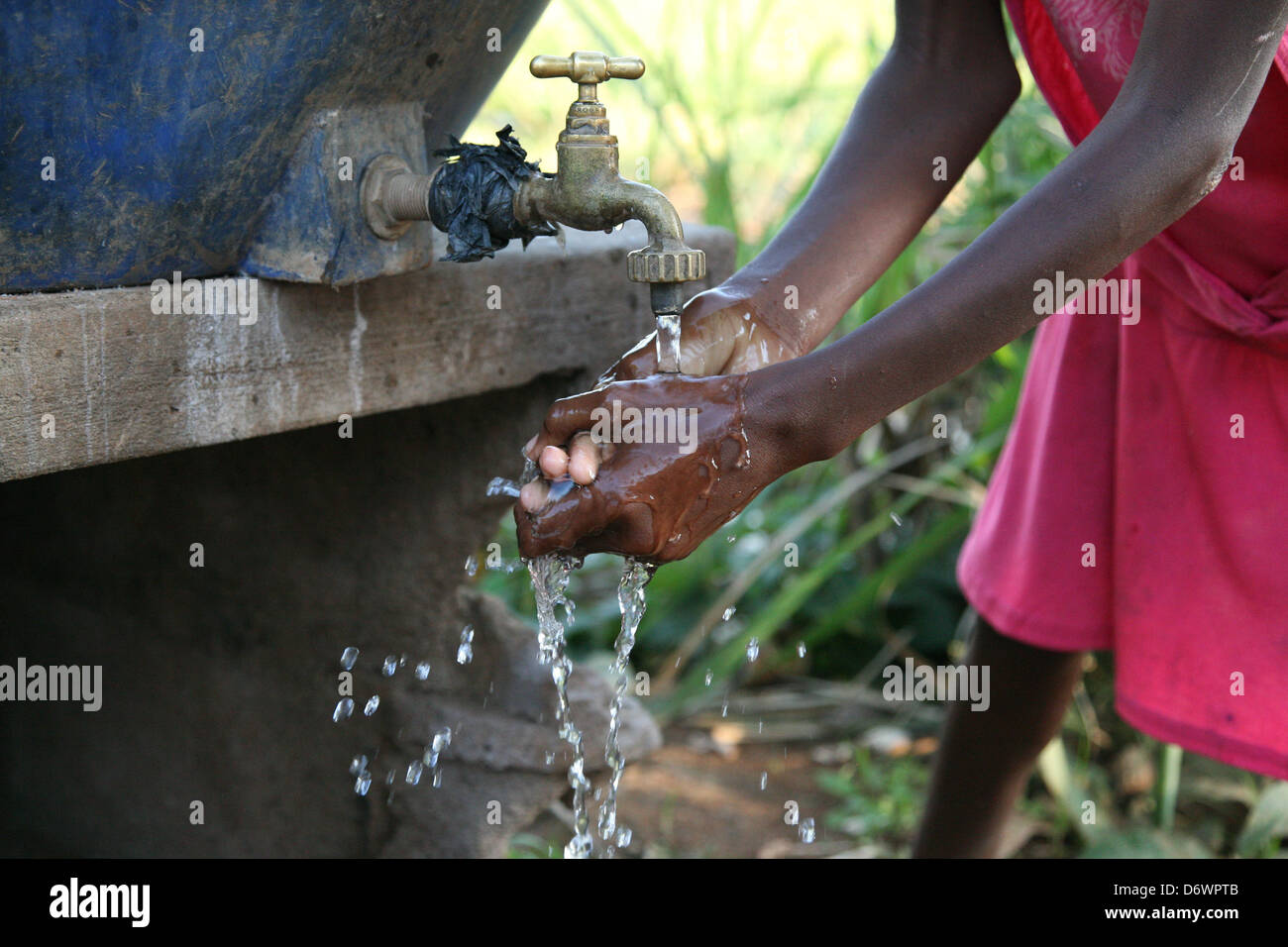 Close up of African hands being washed in clean running water Stock ...