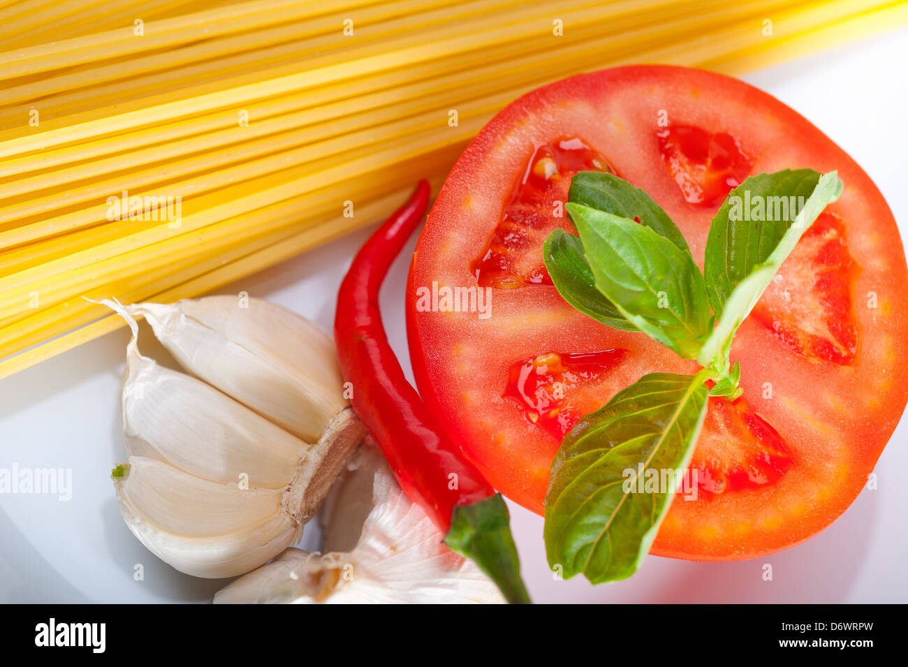 Italian spaghetti pasta tomato raw ingredients basil garlic and red ...