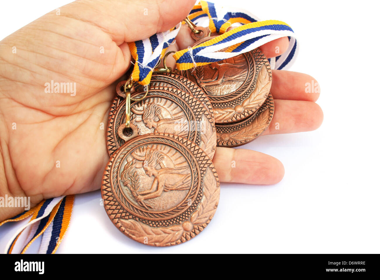 Medals in hand isolated on white background Stock Photo - Alamy