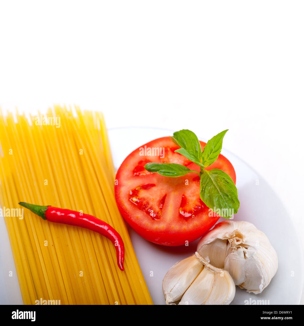 Italian spaghetti pasta tomato raw ingredients basil garlic and red ...