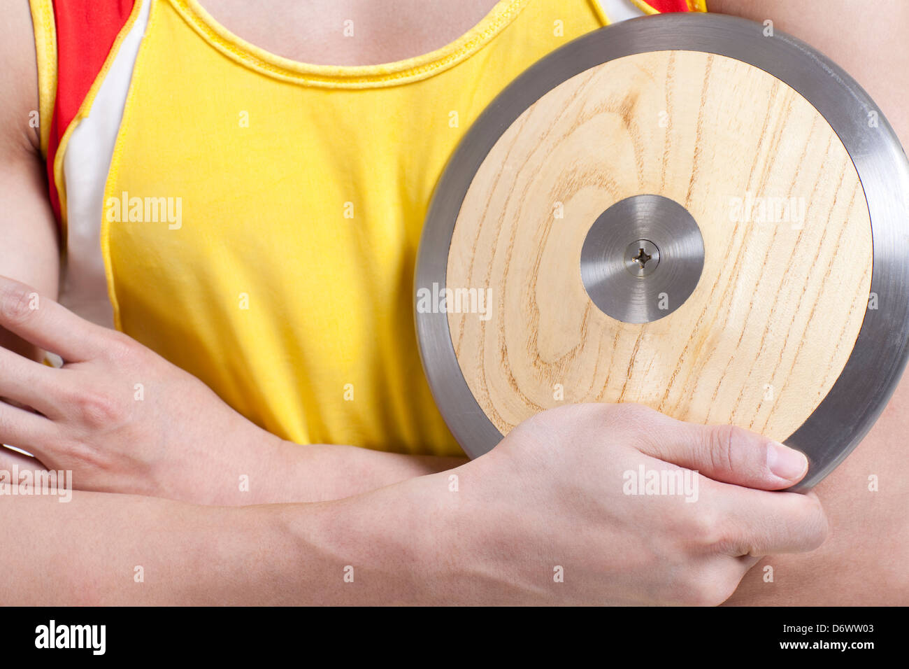 Midsection of male athlete with discus Stock Photo - Alamy