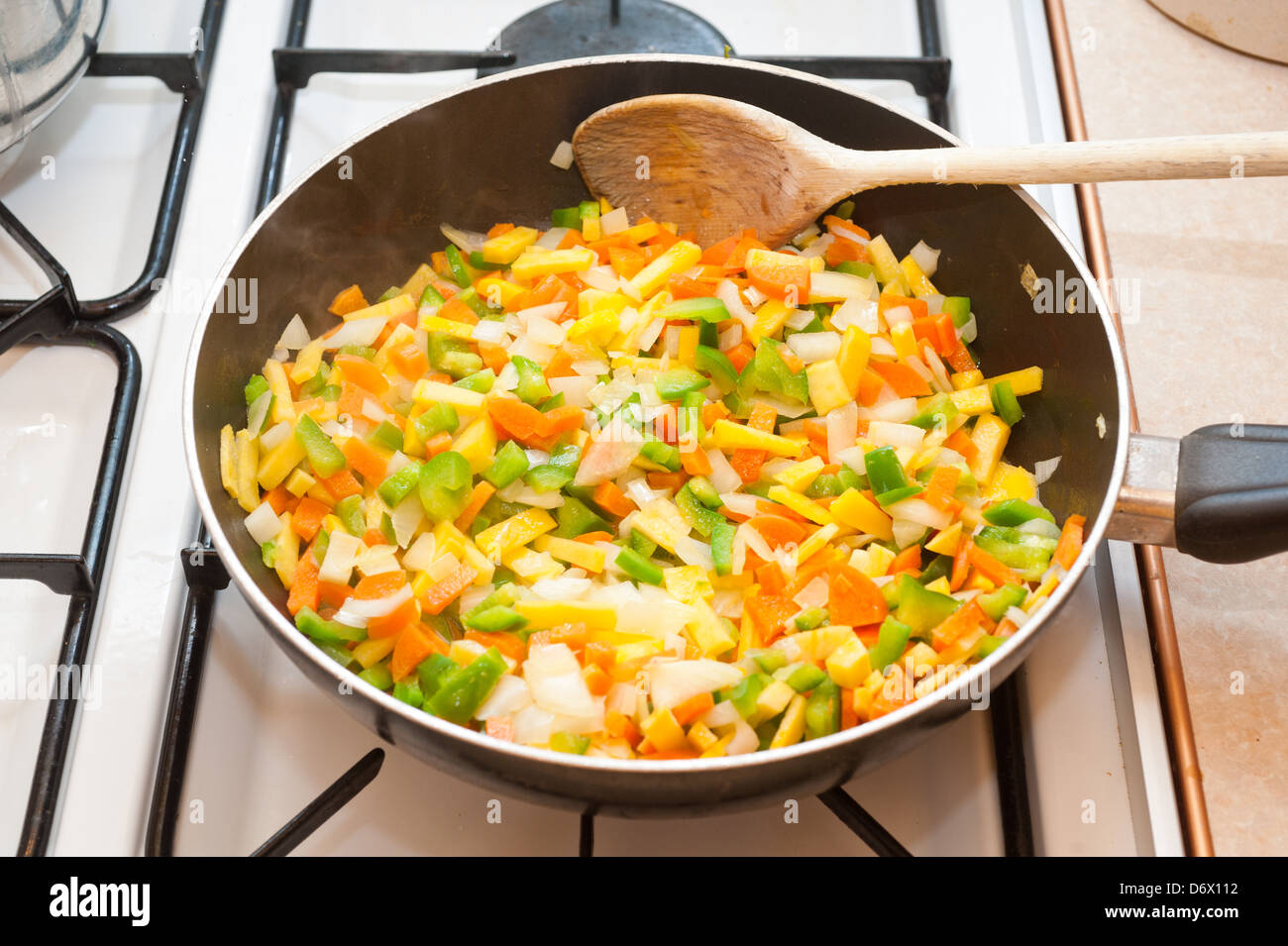 Vegetables cooking in a frying pan Stock Photo - Alamy