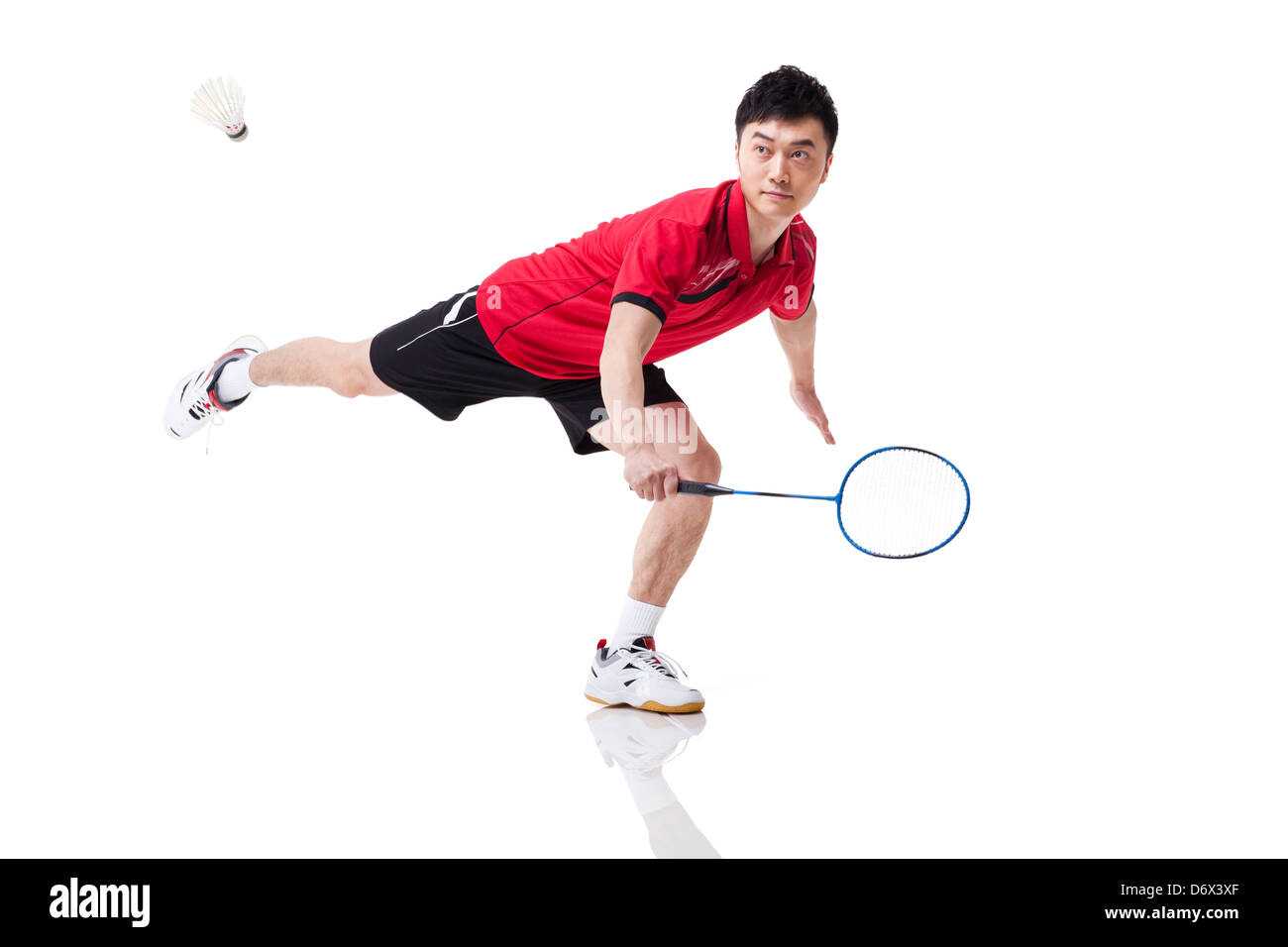Male athlete playing badminton Stock Photo - Alamy