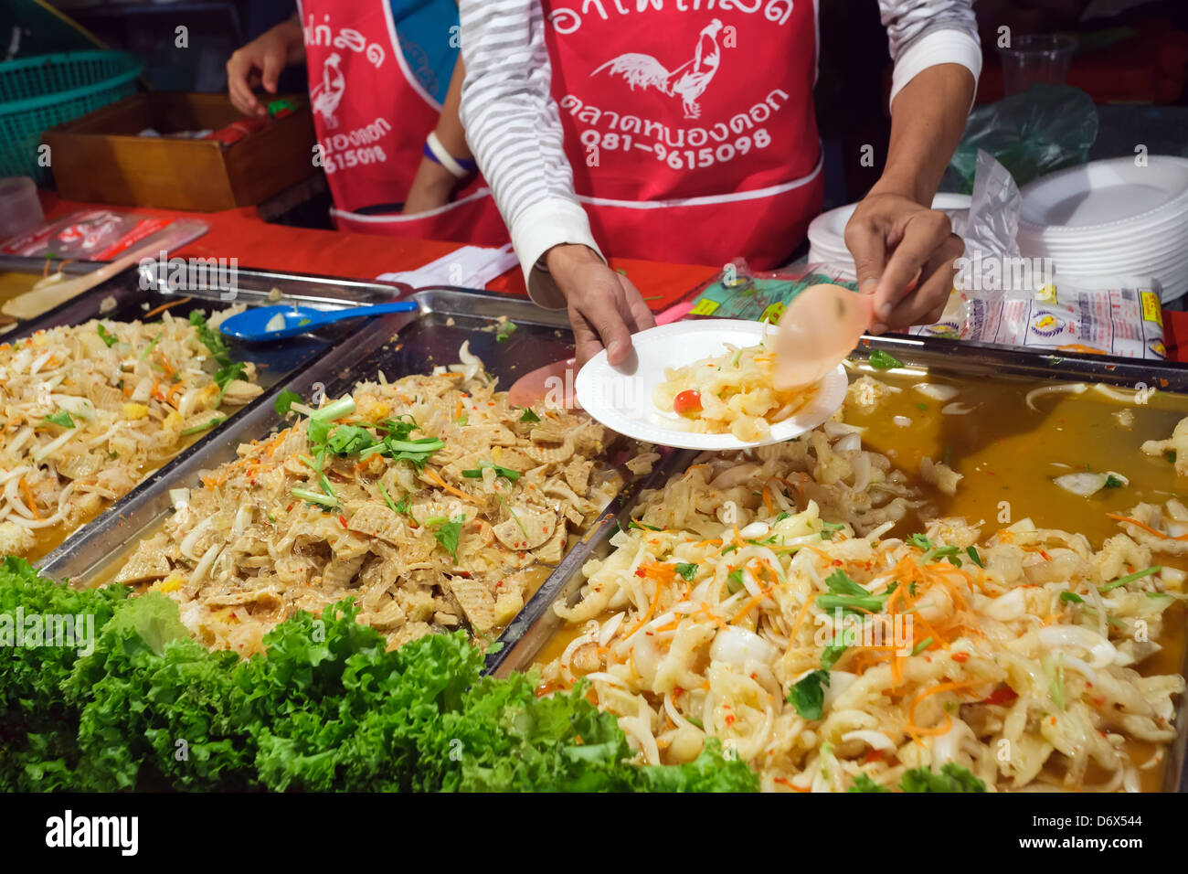 Sellers serving food in Thai street restaurant, Chiang Mai, Thailand ...