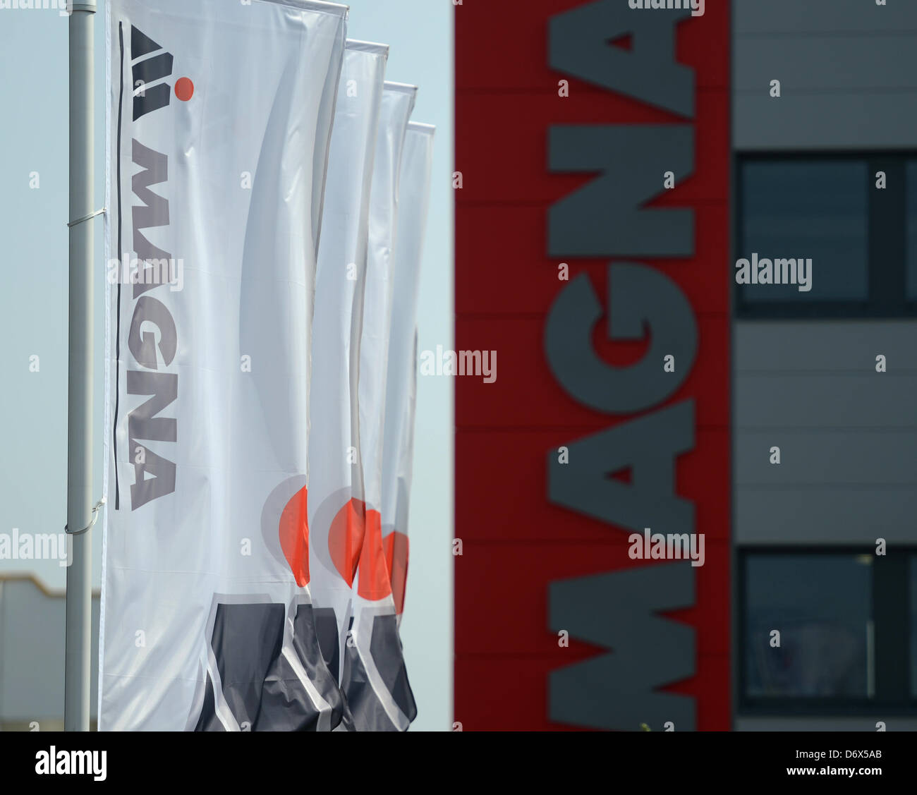 Flags with the logo of Canadian-Austrian automotive supplier Magna ...