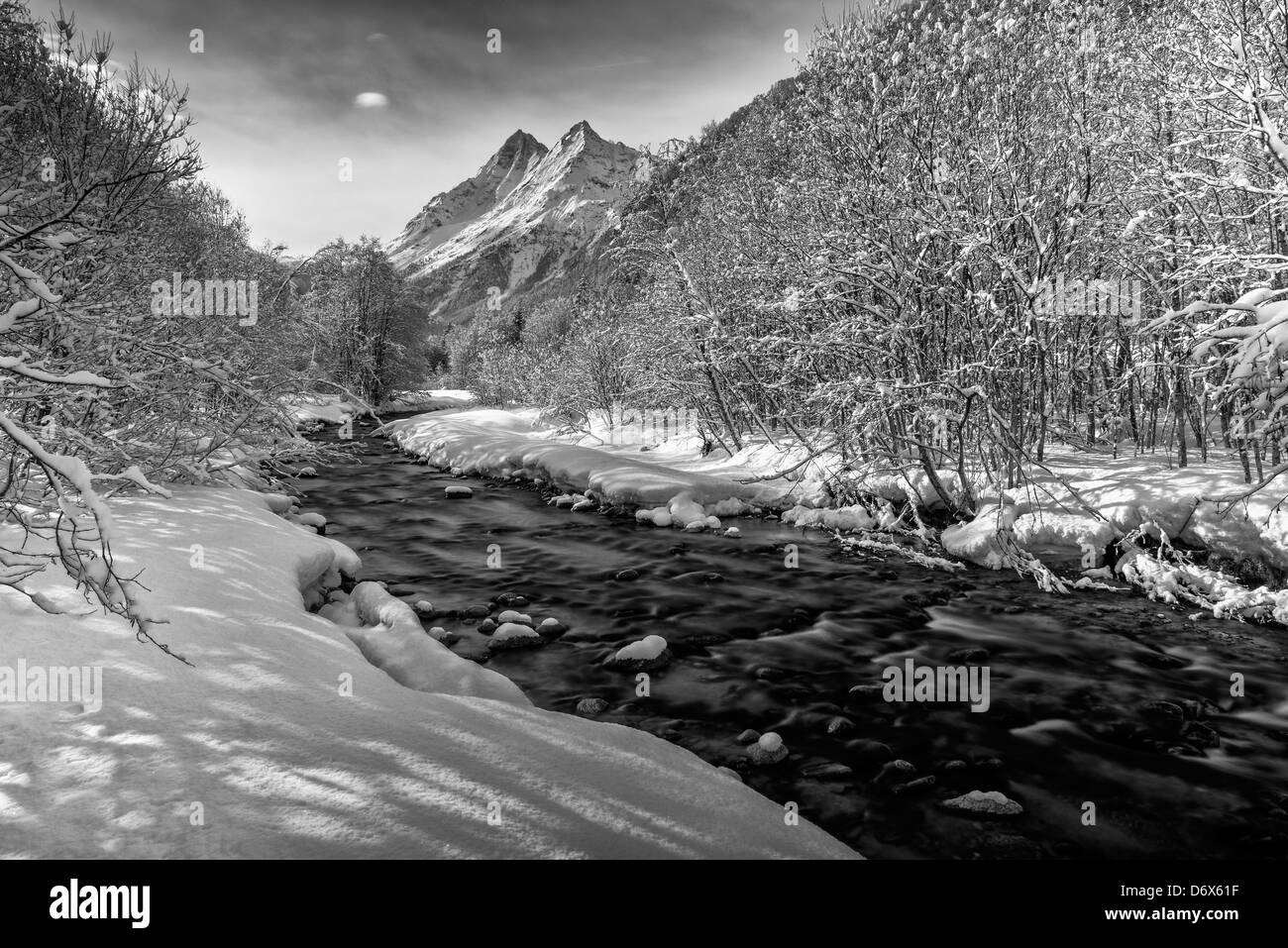 A snowy riverside scene in Switzerland Stock Photo - Alamy