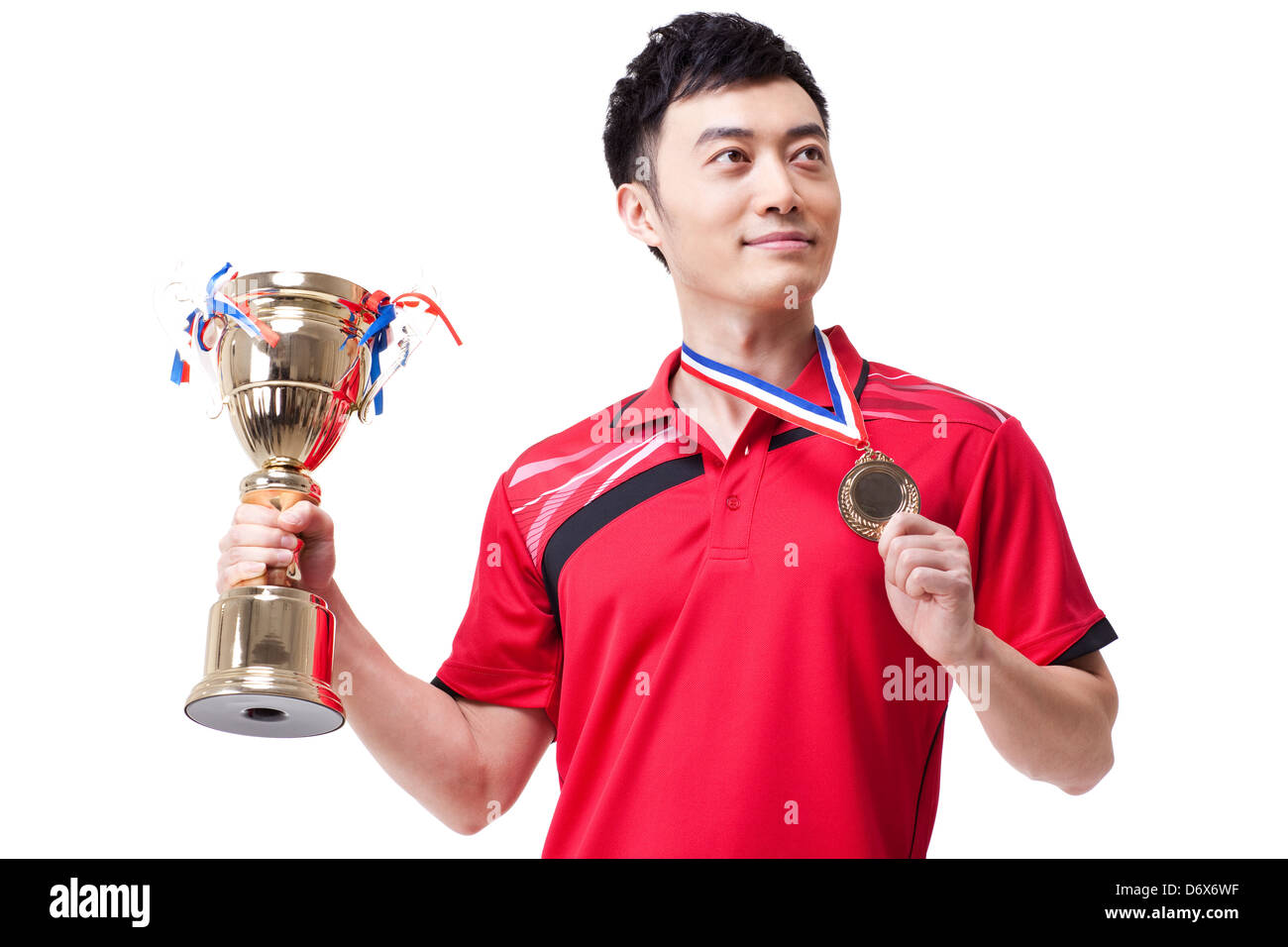 Male athlete celebrating victory with gold medal and trophy Stock Photo ...