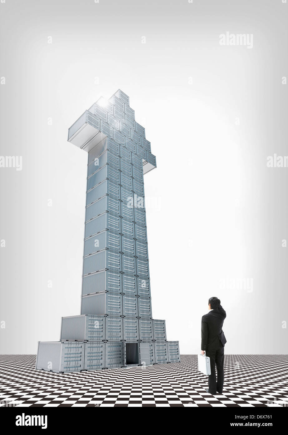 a businessman looking up a pile of boxes in arrow shape Stock Photo - Alamy