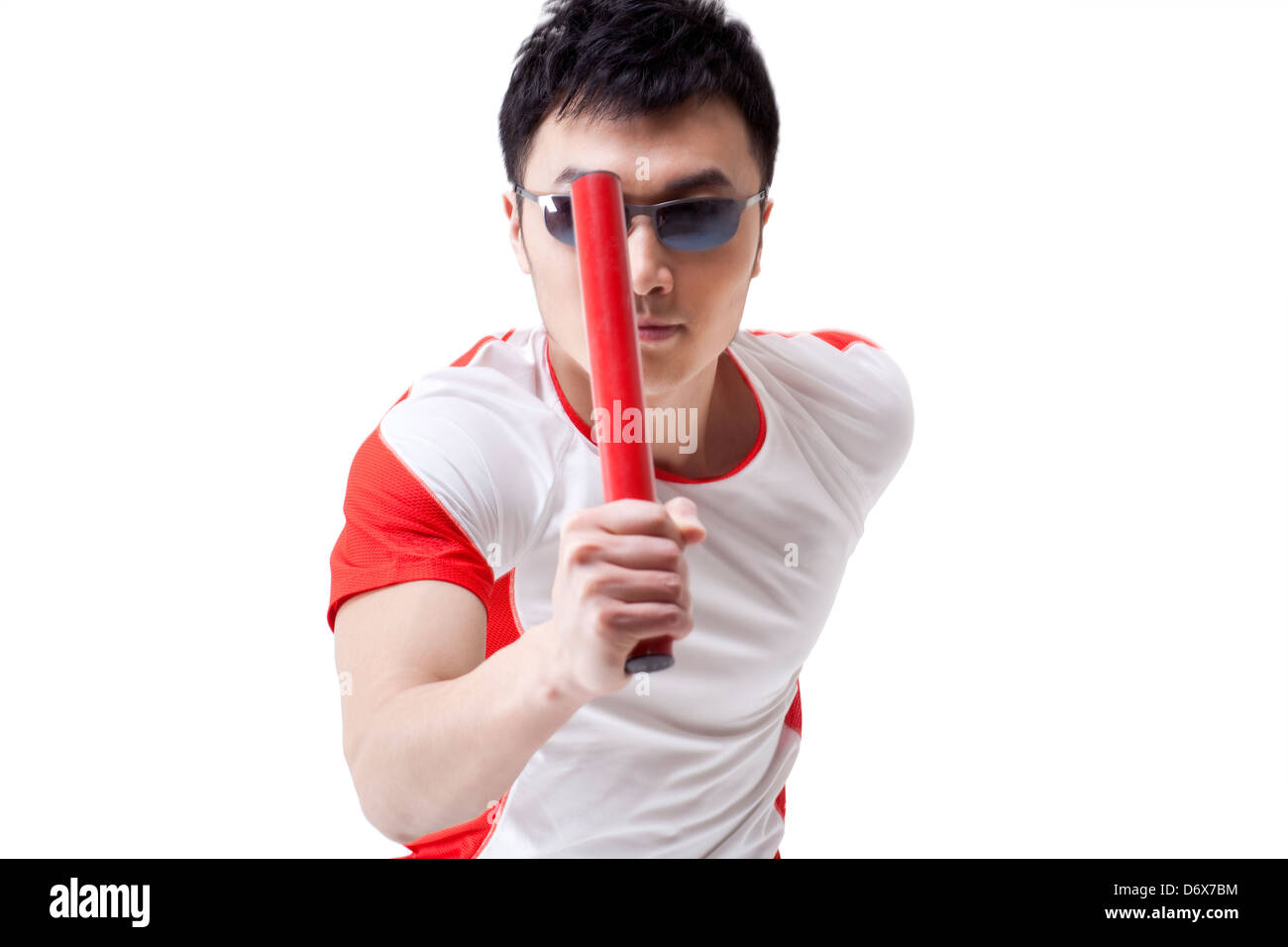 Male athlete running with relay baton Stock Photo - Alamy