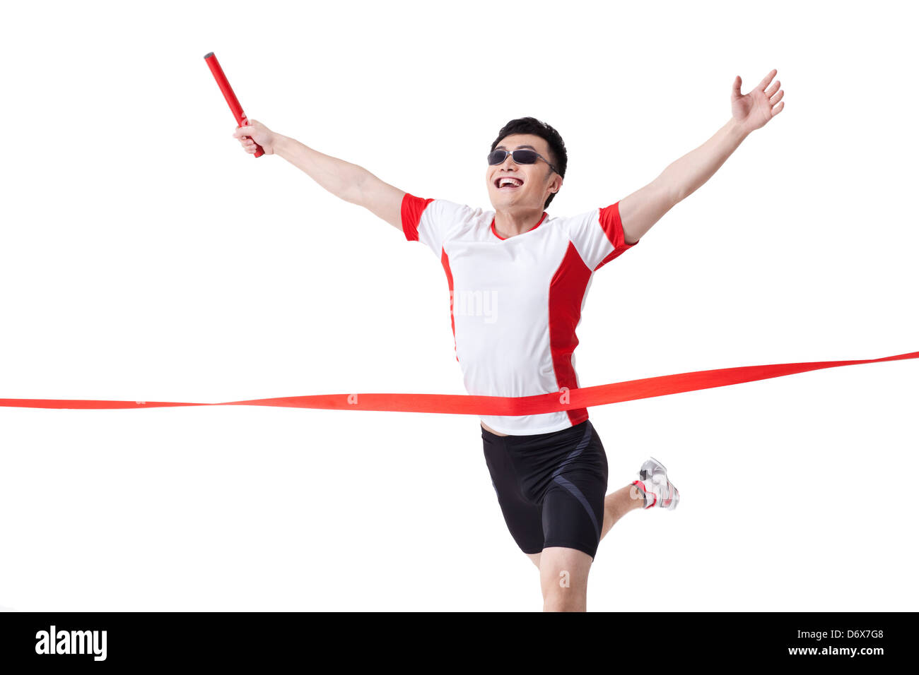 Male athlete with relay baton reaching the finish line Stock Photo - Alamy