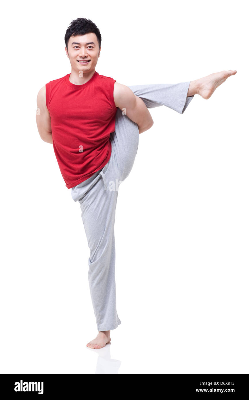 Young man doing yoga Stock Photo - Alamy