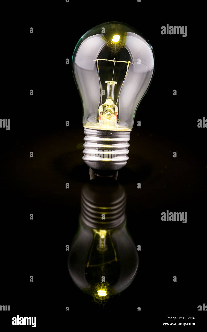 Light bulb on black background, reflection Stock Photo - Alamy