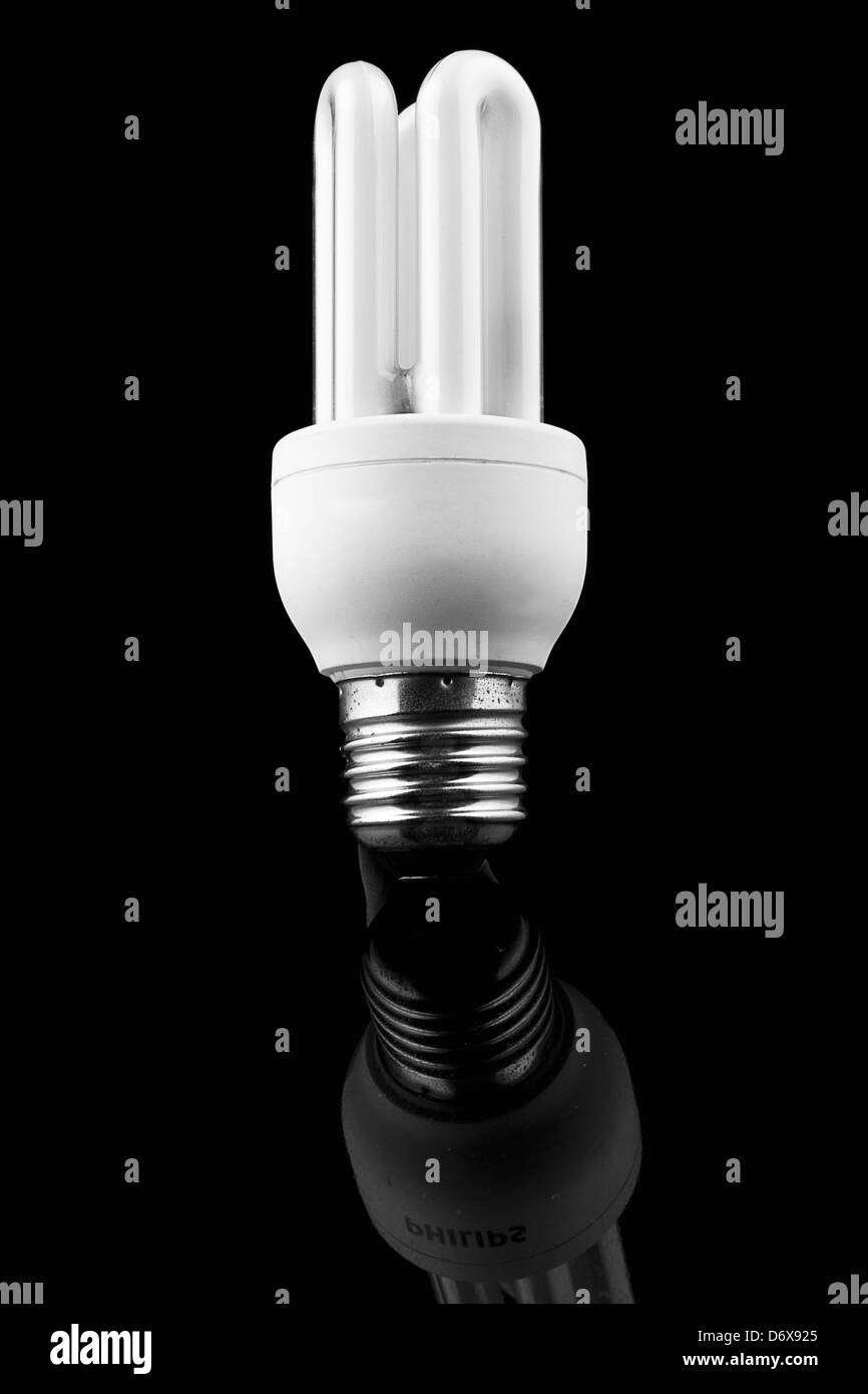 Light bulb on black background, energy saver Stock Photo - Alamy