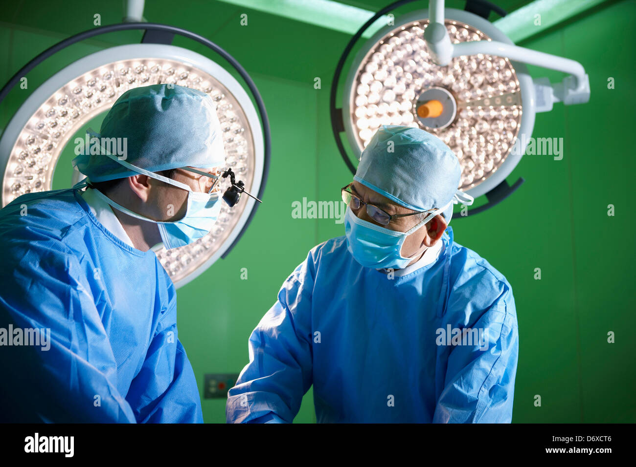 surgeons doing a surgery in operating room Stock Photo - Alamy