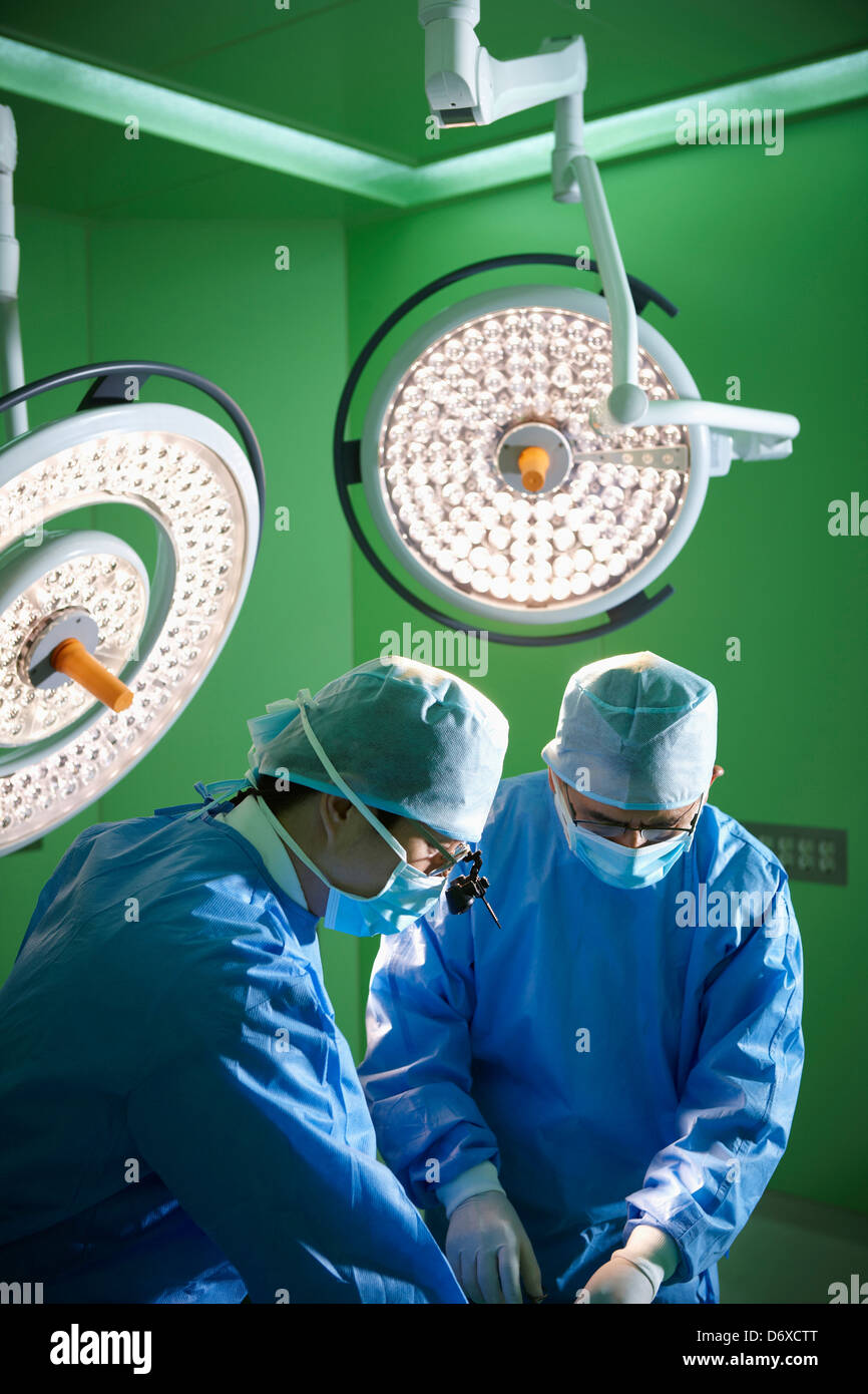 surgeons doing a surgery in operating room Stock Photo - Alamy