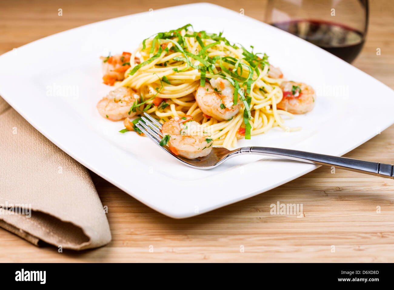 Closeup horizontal photo of Pasta dish with focus on large shrimp in ...