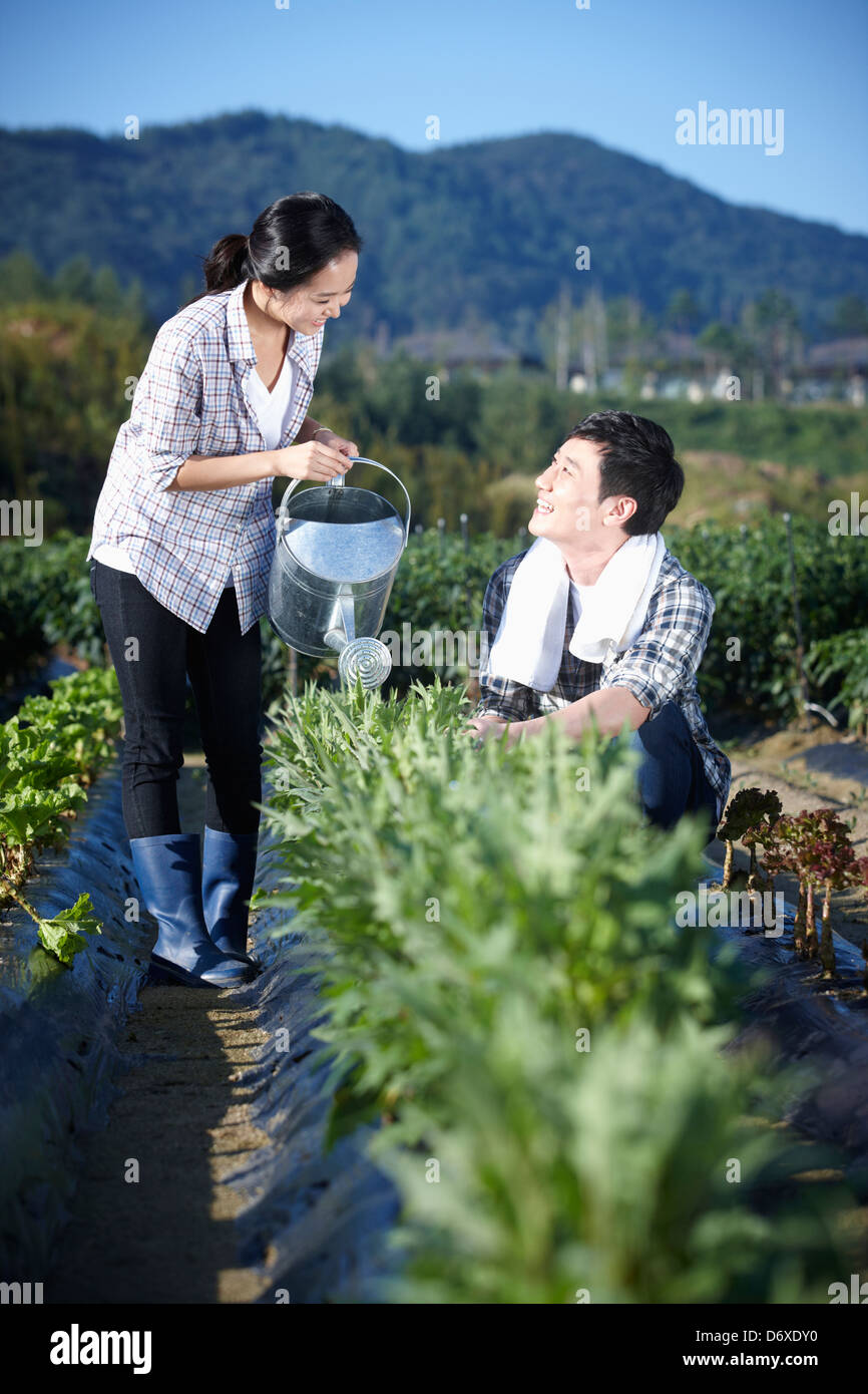 a couple in a farm enjoying planting Stock Photo - Alamy