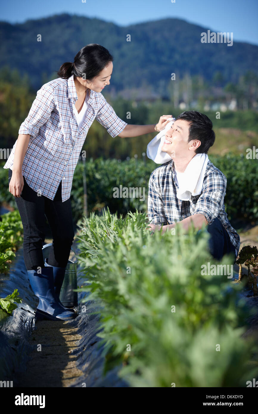 a couple in a farm enjoying planting Stock Photo - Alamy