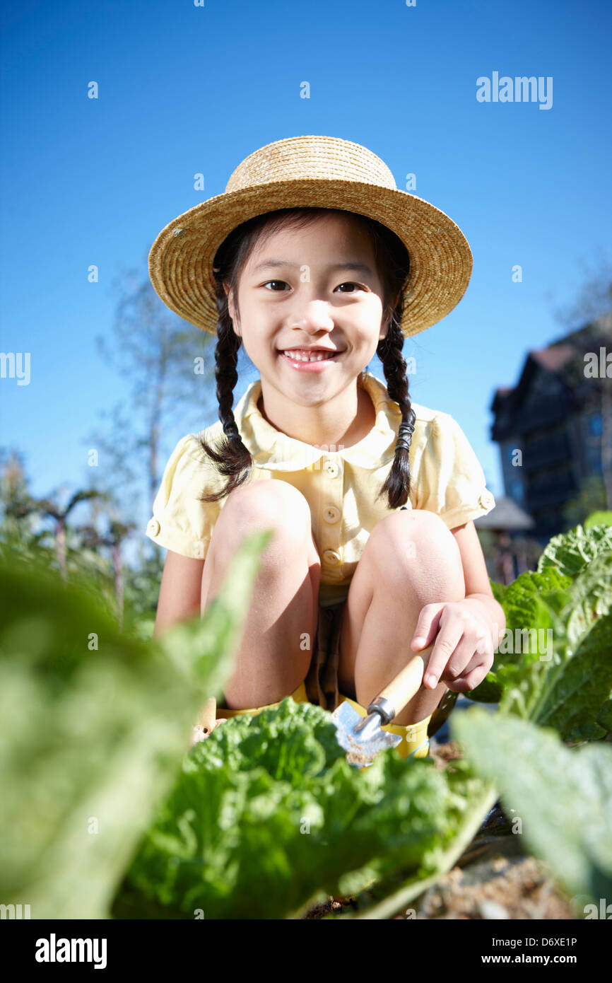 a girl in a farm digging the crop Stock Photo - Alamy