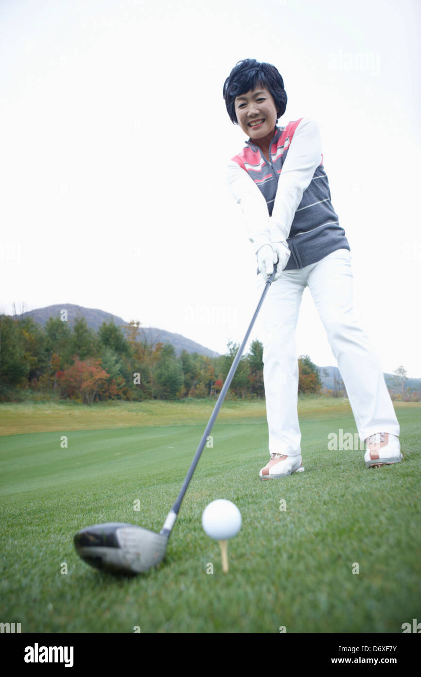 Senior woman playing golf holding club hi-res stock photography and ...