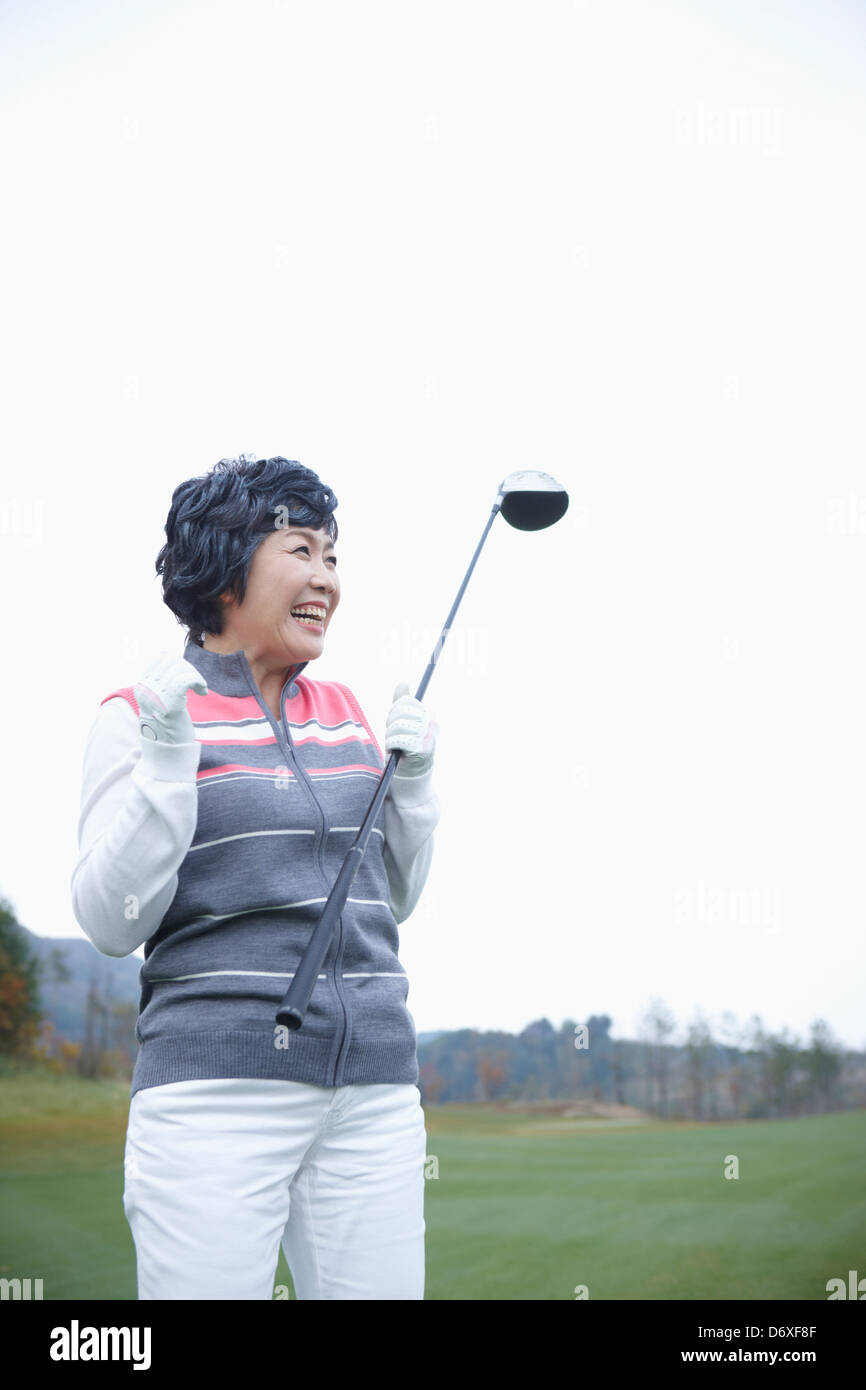 a excited woman at a golf course Stock Photo - Alamy