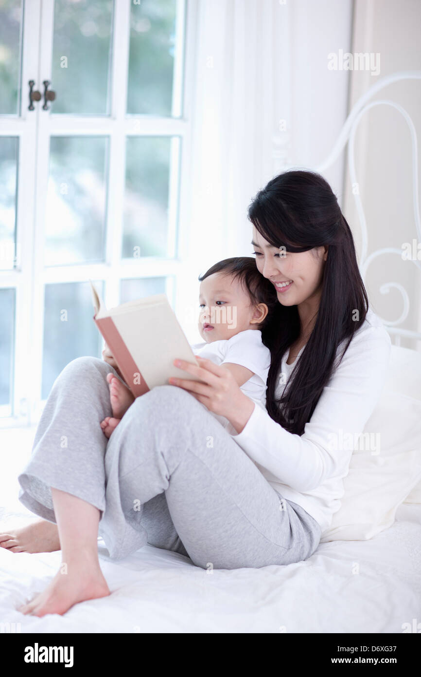 mother and baby reading a book together Stock Photo - Alamy