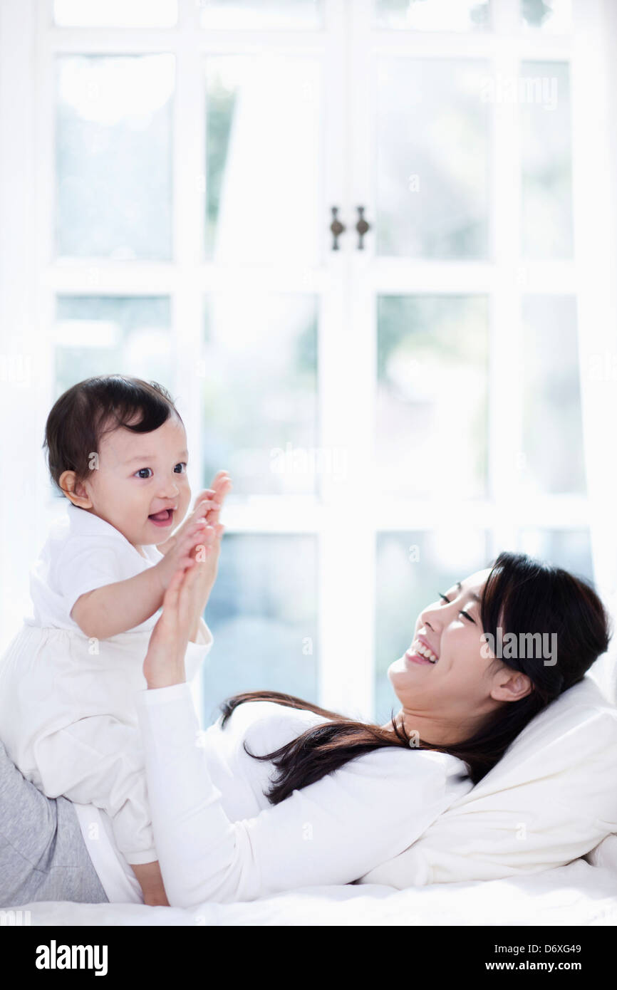 Baby sitting on mothers belly hi-res stock photography and images - Alamy