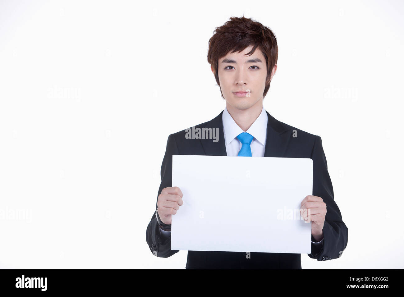 a man in business suit holding an empty white board Stock Photo - Alamy