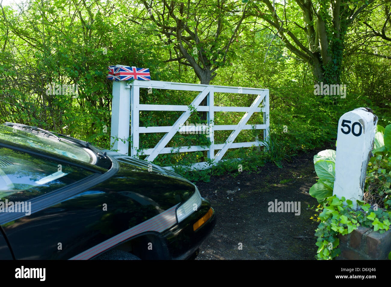 Car at gate to woods, union jack flag Stock Photo - Alamy