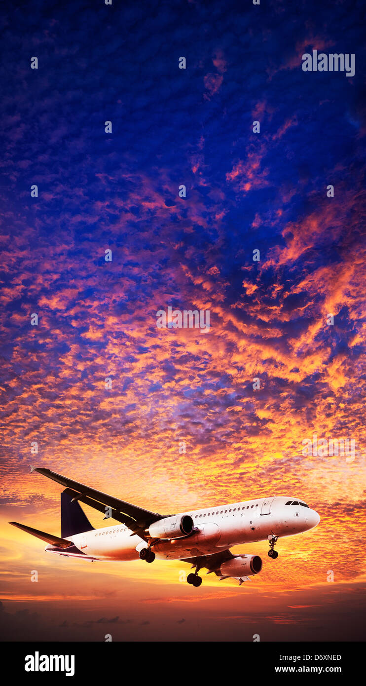 Jet is maneuvering in spectacular sunset sky Stock Photo - Alamy