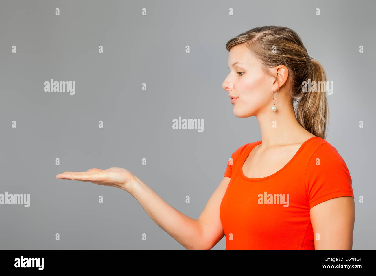An image of a nice young woman presenting something Stock Photo - Alamy
