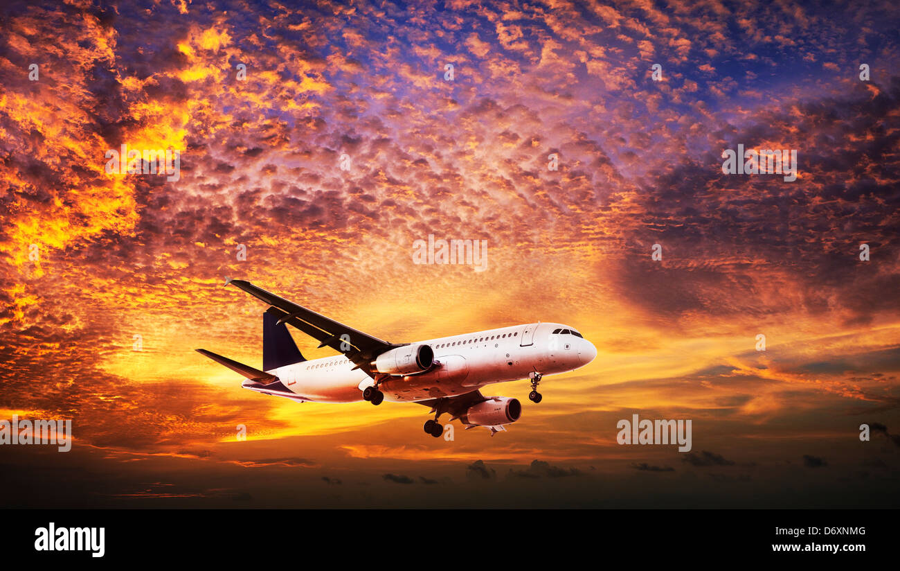Jet is maneuvering in spectacular sunset sky Stock Photo - Alamy