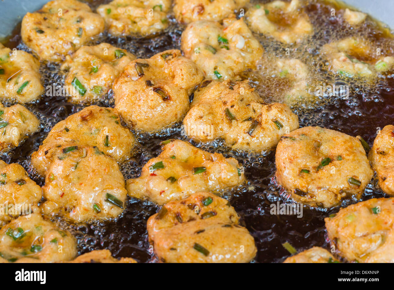 Deep frying fish cake for sale in market Stock Photo - Alamy