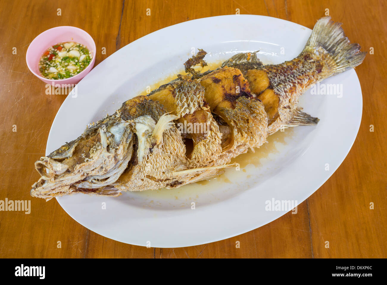Seep Fried sea bass with fish sauce serve with seafood sauce Stock ...
