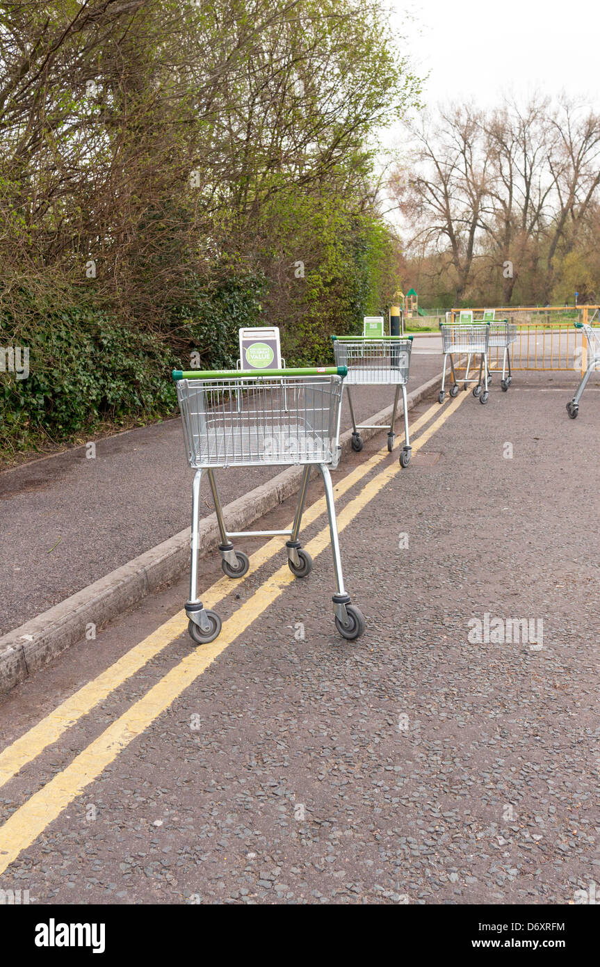 Line of Waitrose supermarket trolleys parked on double yellow lines ...