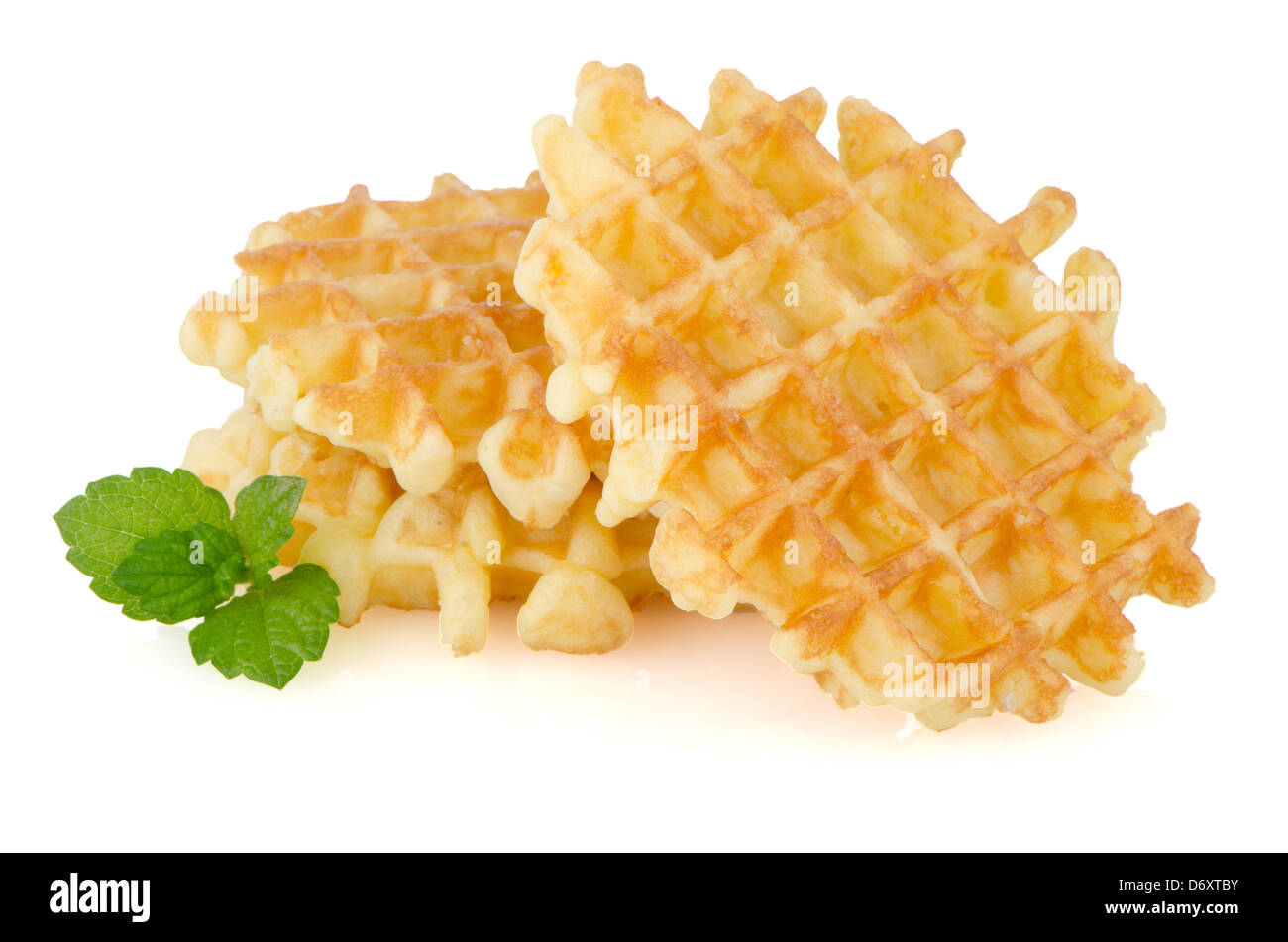 Pile of sweet waffles with green mint leaves isolated on white ...