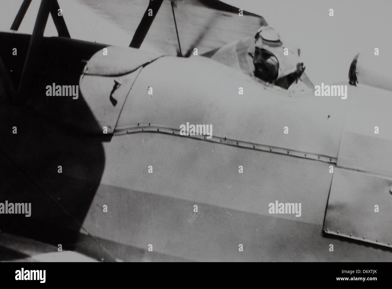 This photo features a woman pilot in the cockpit of an aircraft ...