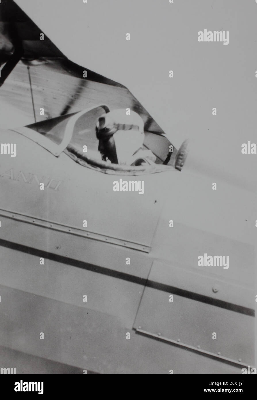 This photograph captures a woman in the cockpit of an aircraft ...