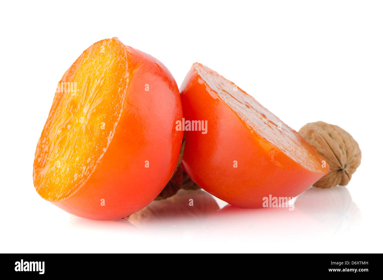 Ripe persimmons and nuts on white background Stock Photo - Alamy