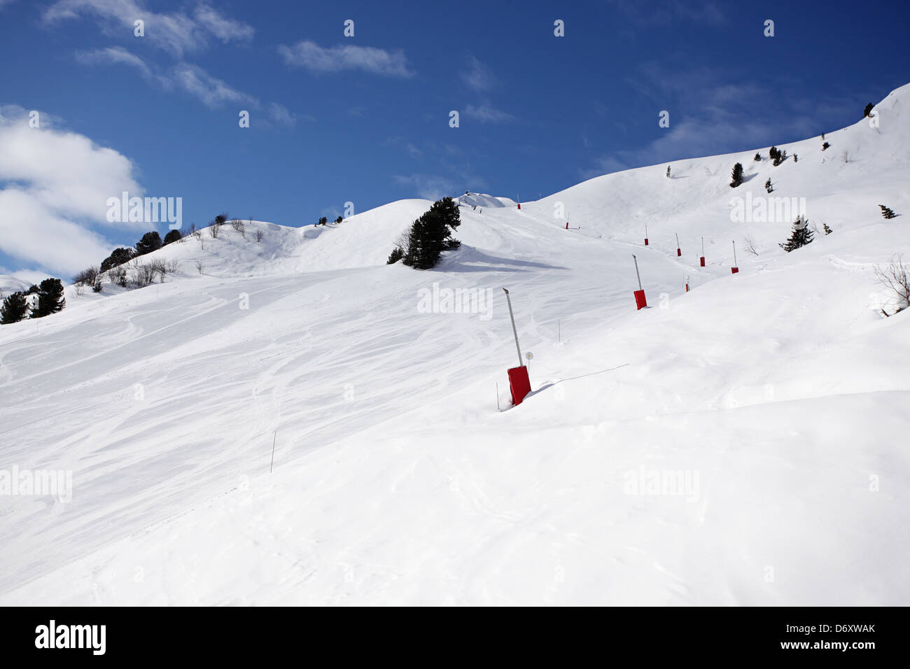 A lovely ski run early morning with freshly pisted snow and clear blue ...