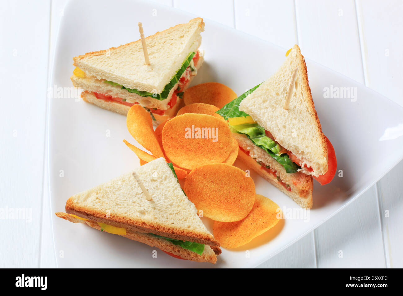 Vegetable sandwich triangles and spicy crisps Stock Photo - Alamy
