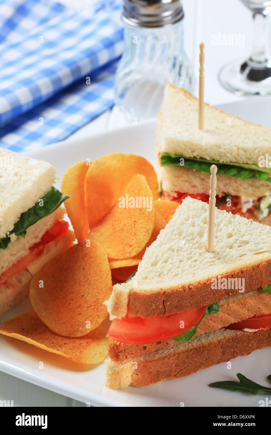 Vegetable sandwich triangles and spicy crisps Stock Photo - Alamy