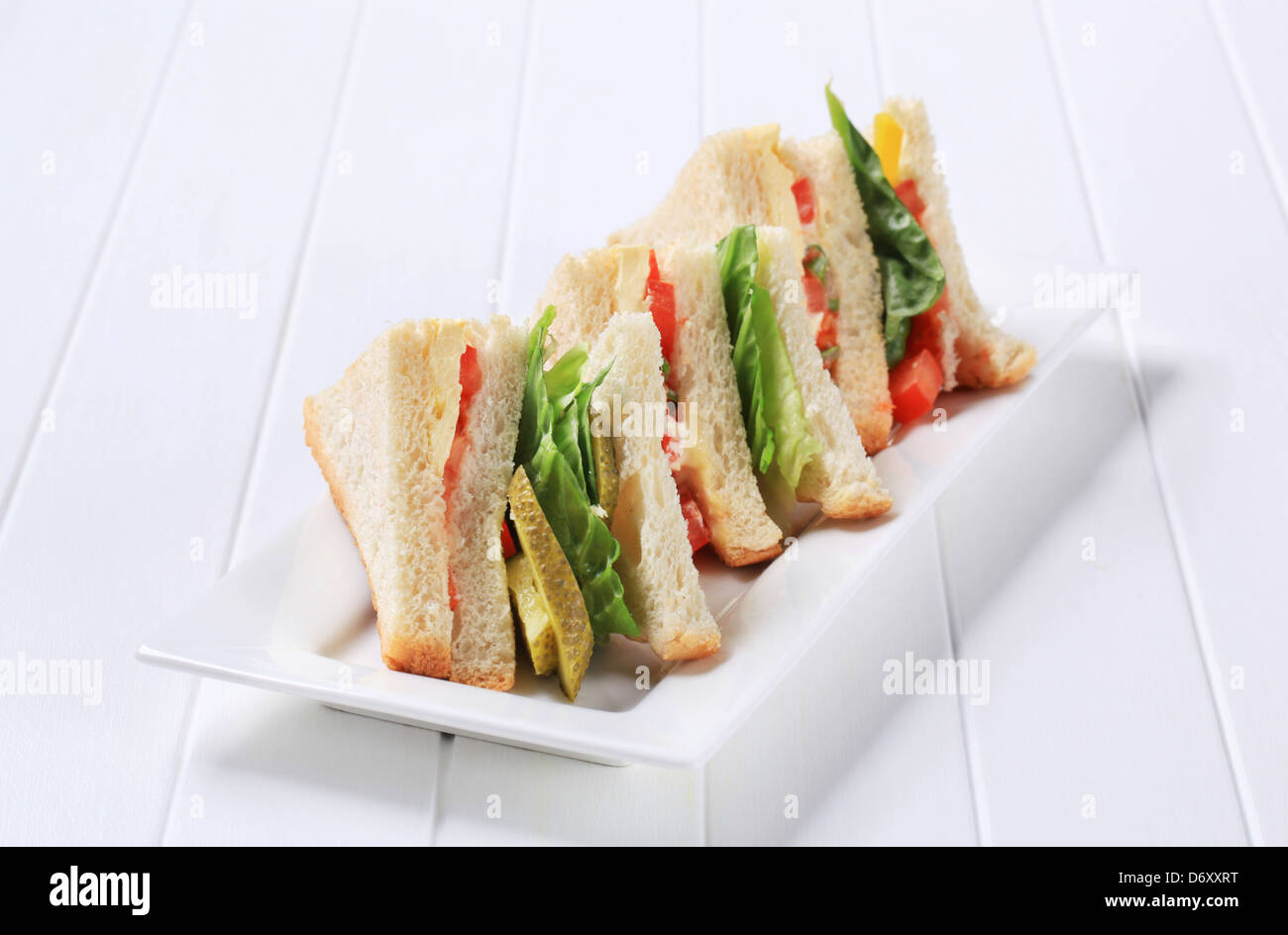 Vegetable sandwich triangles on cutting board Stock Photo - Alamy