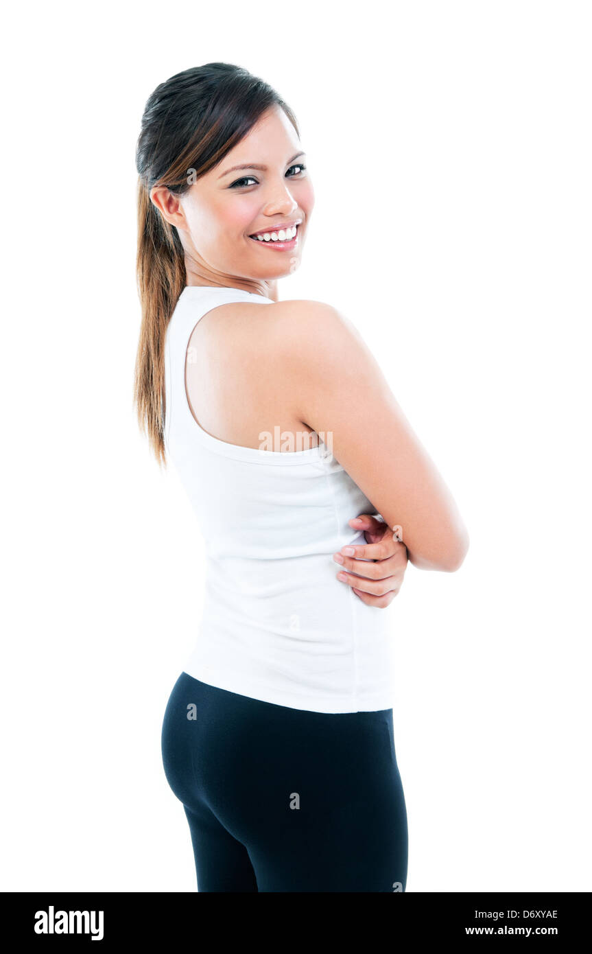 Happy young woman turning her back and looking towards camera, portrait ...