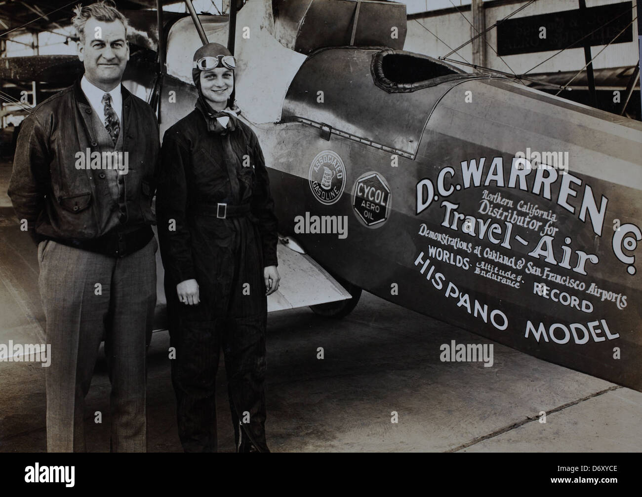 Louis Thaden poses with D.C. Warren in front of a historic airplane ...