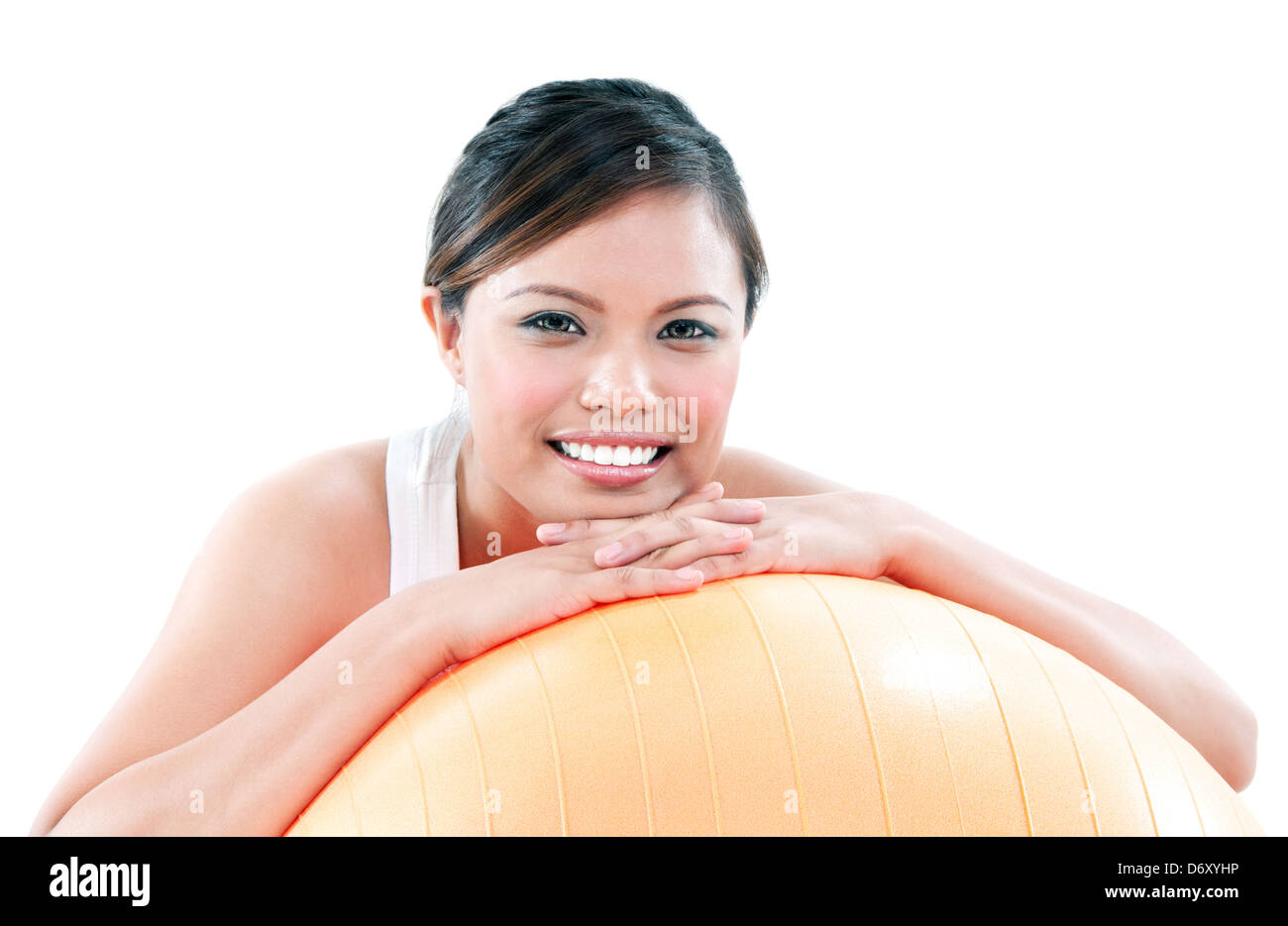 Portrait of a pretty young woman leaning on balance ball, isolated on ...