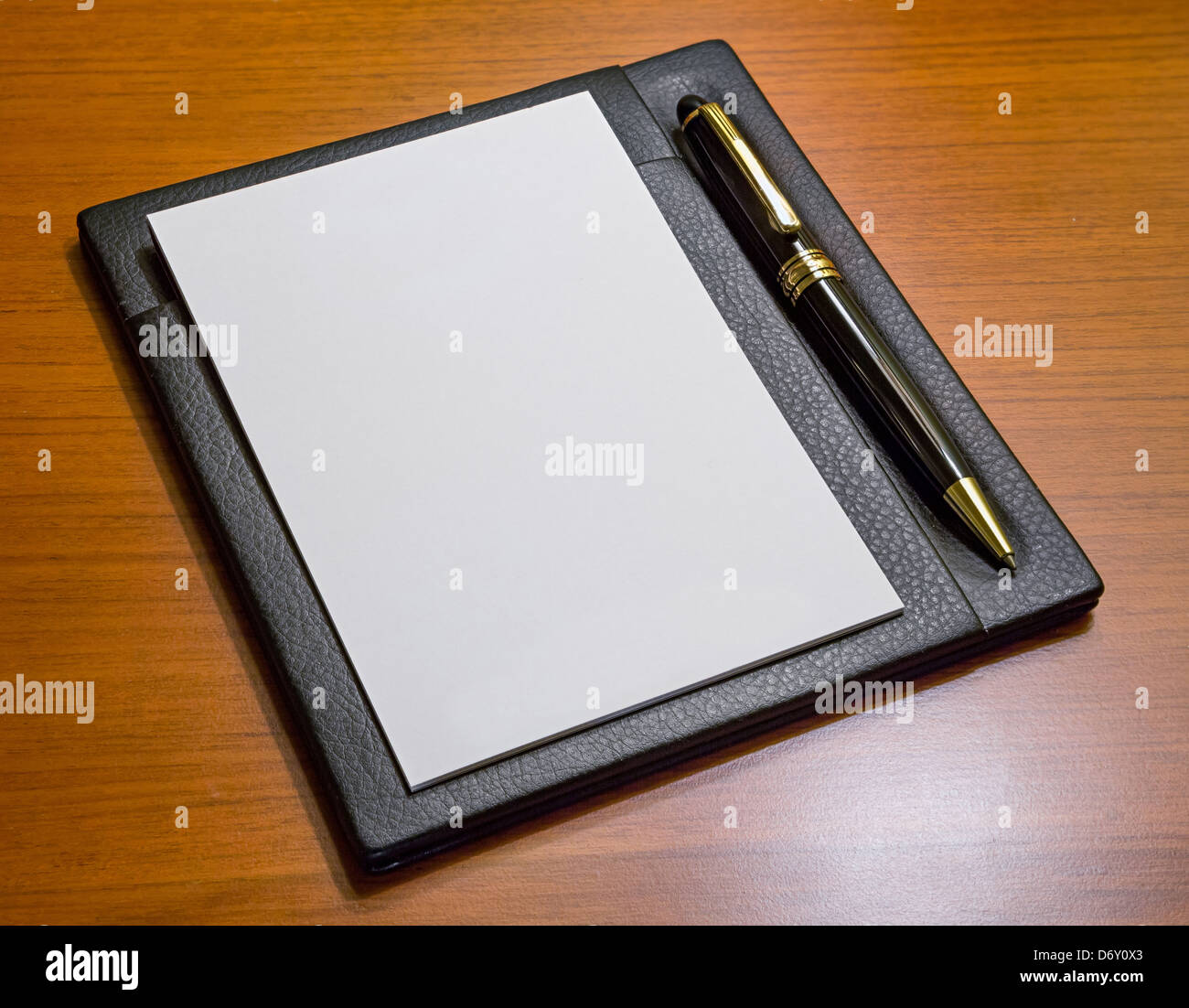 Elegance Note Paper with luxury pen in leather holder on wood table ...