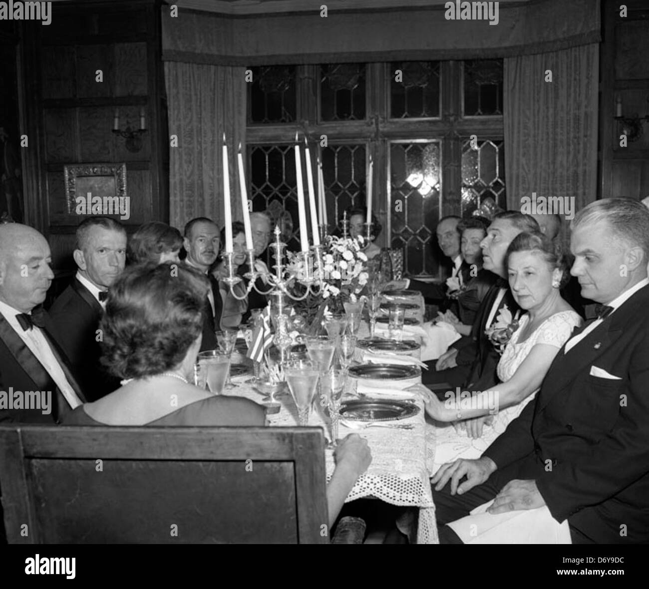 A dinner party in 1959, photographed by Adolph B. Rice Studio, shows a ...