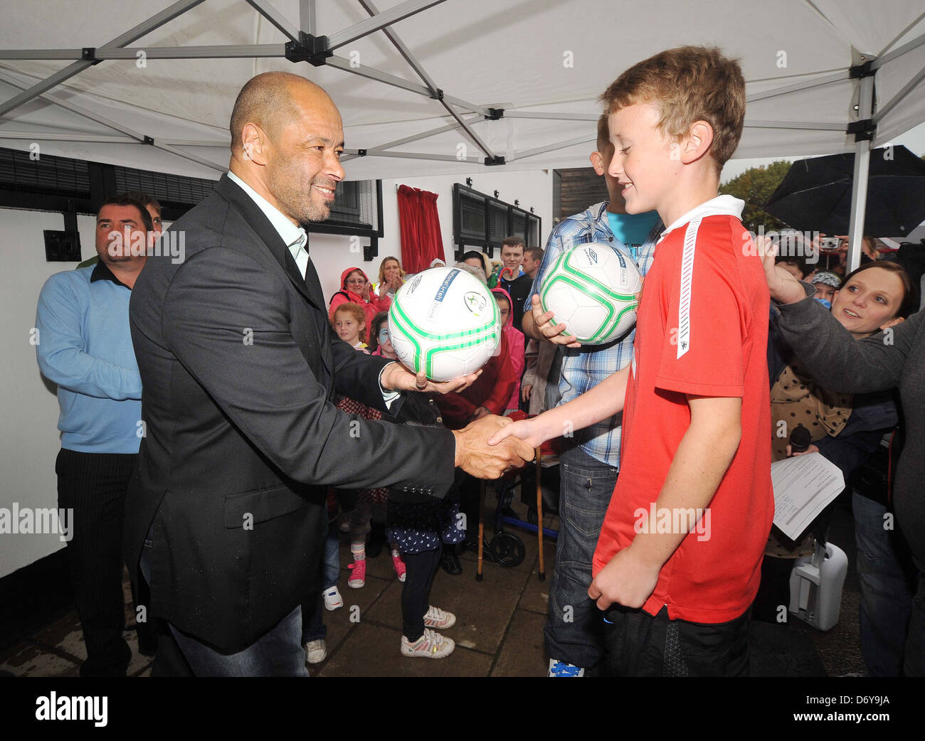 Retired Irish footballer Paul McGrath presents two signed footballs ...